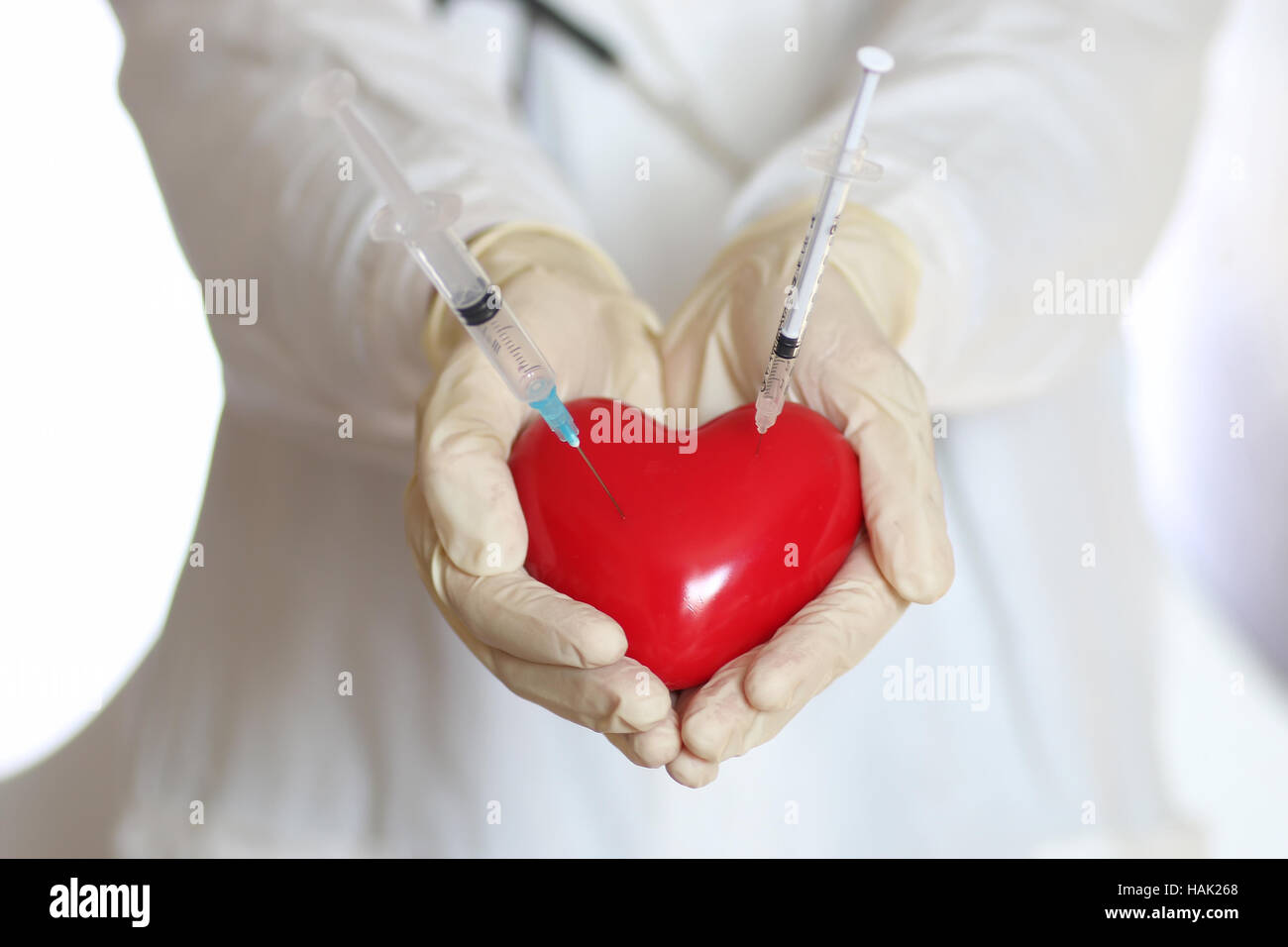 syringe in heart doctor hand Stock Photo - Alamy