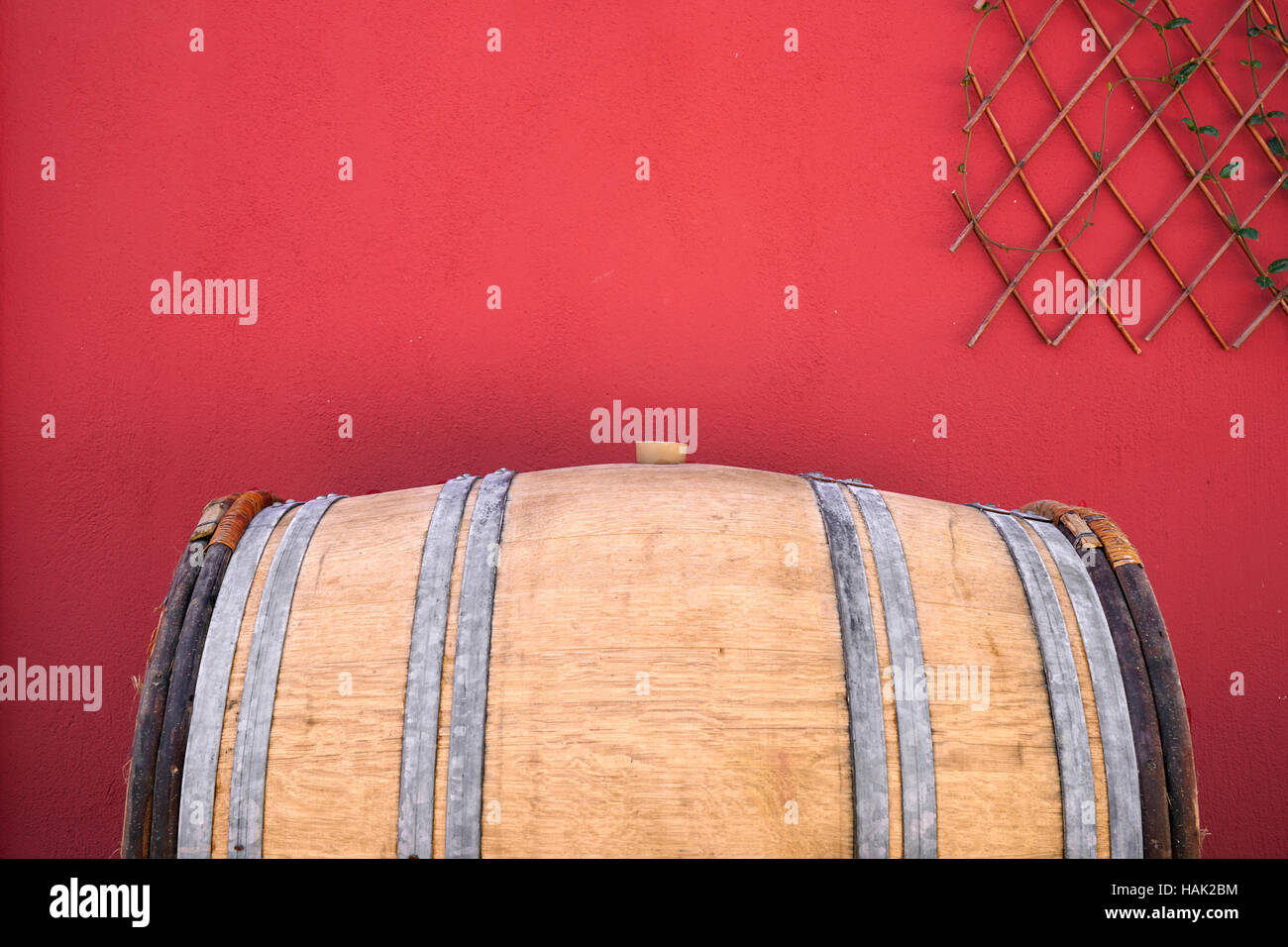 Old wooden barrel on a red background Stock Photo - Alamy