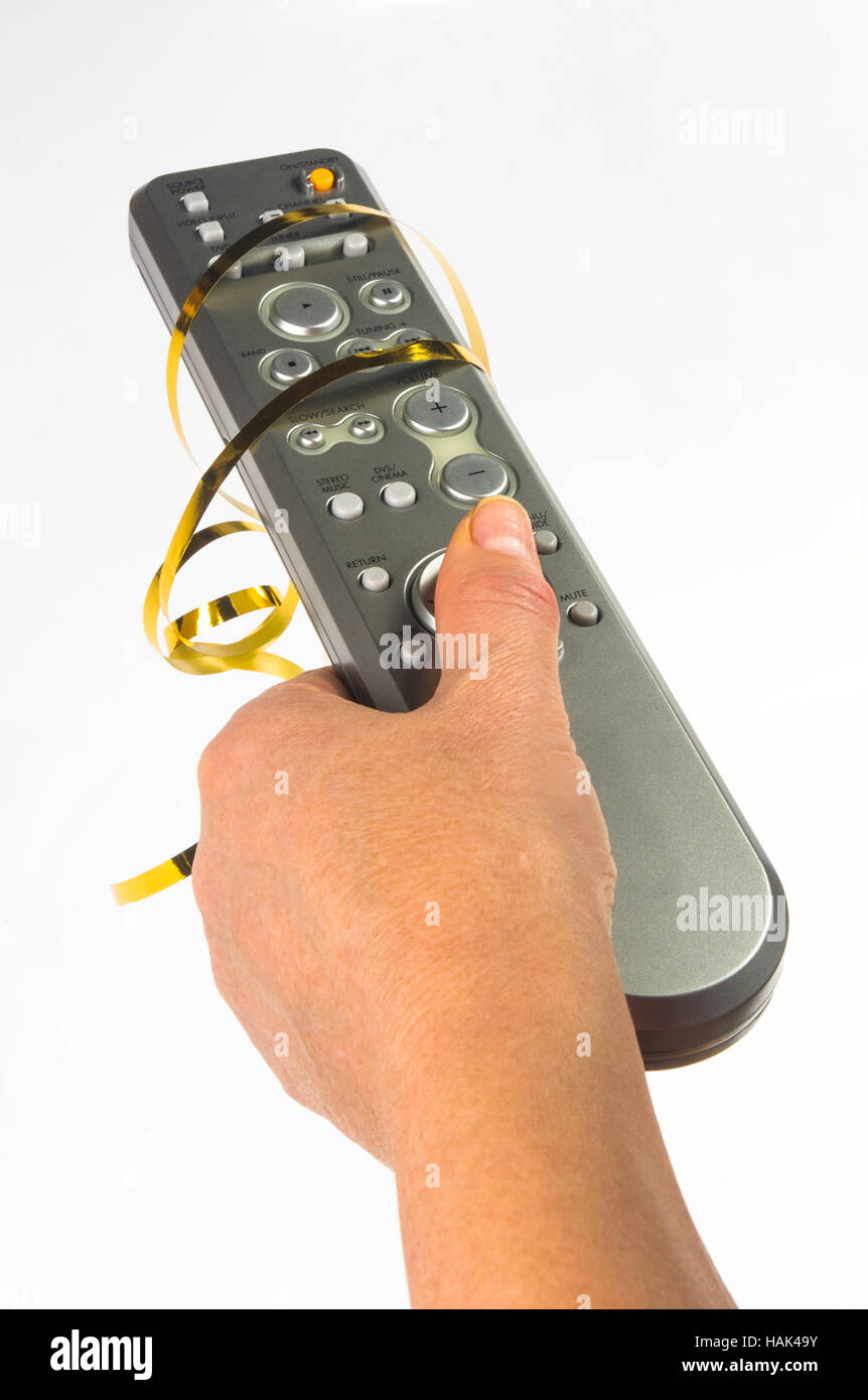 hand holding a remote control in a festive gold ribbon on white ...