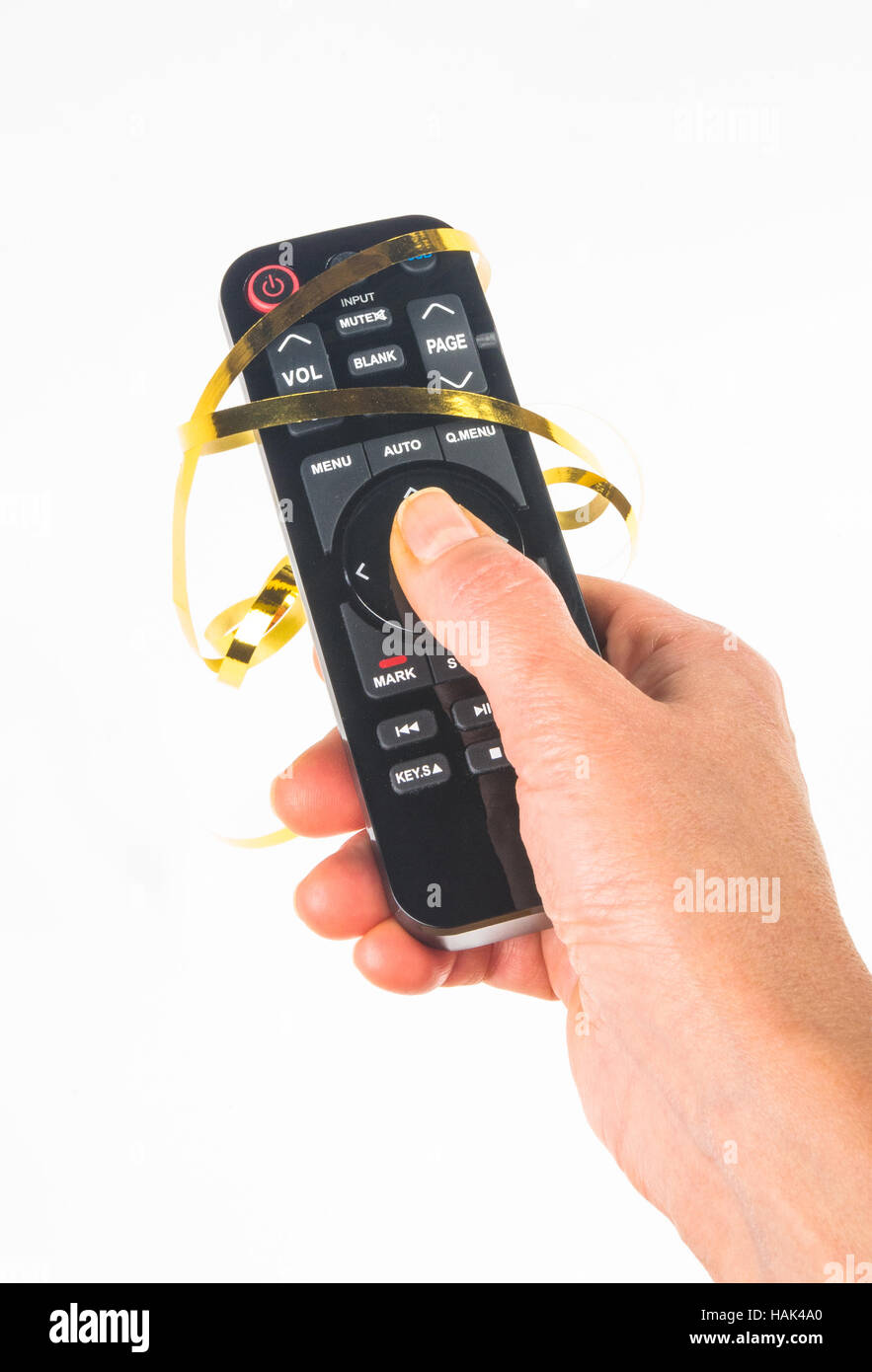 hand holding a remote control in a festive gold ribbon on white ...
