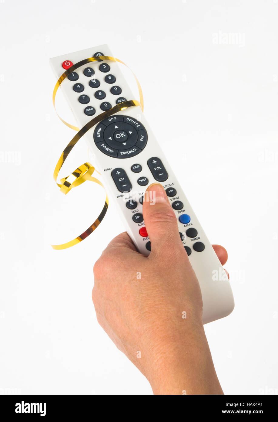 hand holding a remote control in a festive gold ribbon on white ...
