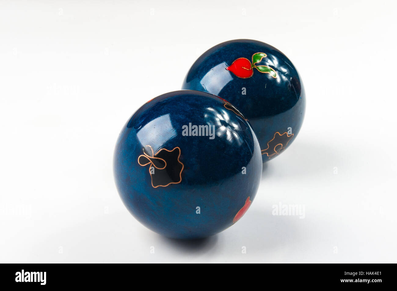 pair of blue Chinese singing balls Baoding of health for hands on white ...