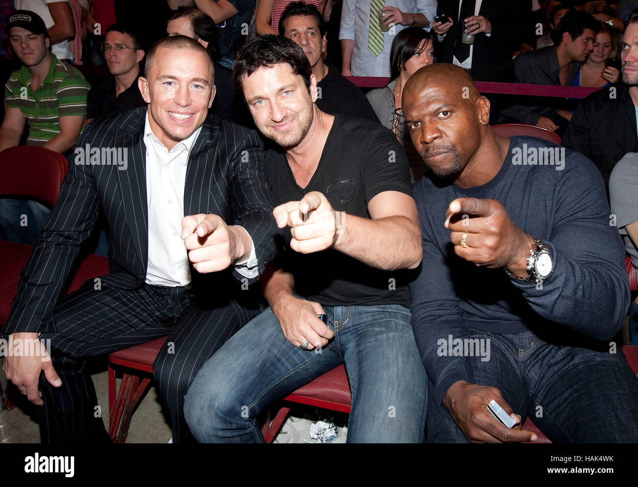 Actor Gerard Butler, center, with UFC fighter Georges St.-Pierre, left ...