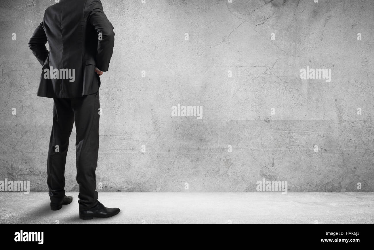 Businessman looking at wall Stock Photo - Alamy