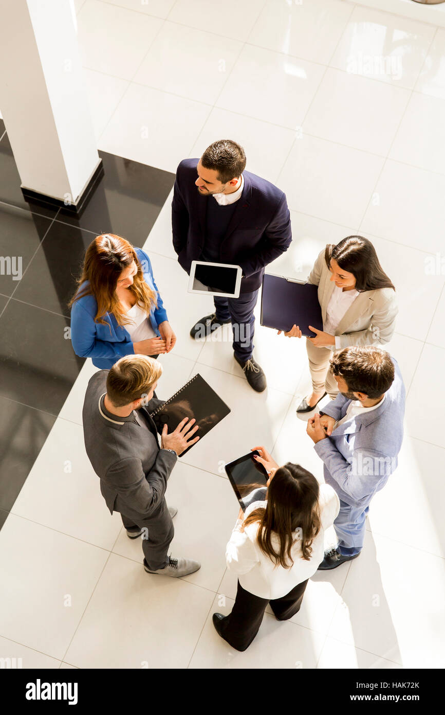 Overhead view of people having business meeting Stock Photo - Alamy