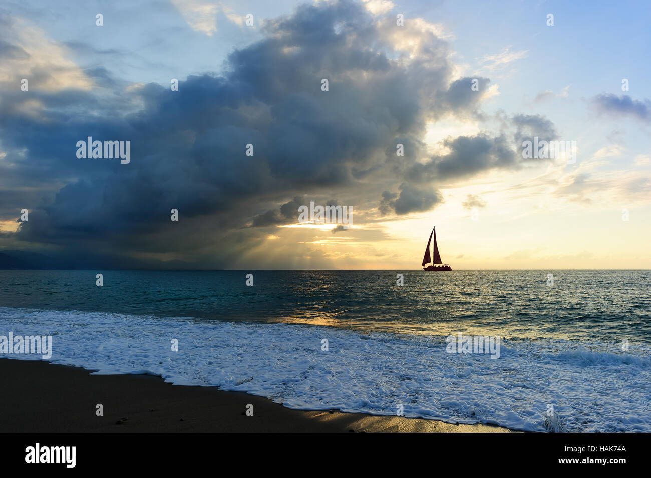 Ocean sunset sailboat sun ray silhouette is a bright uplifting seascape ...