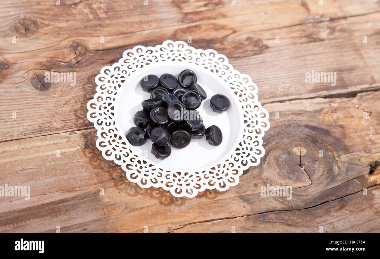 Traditional Dutch candy drop on little plate on wooden background Stock ...