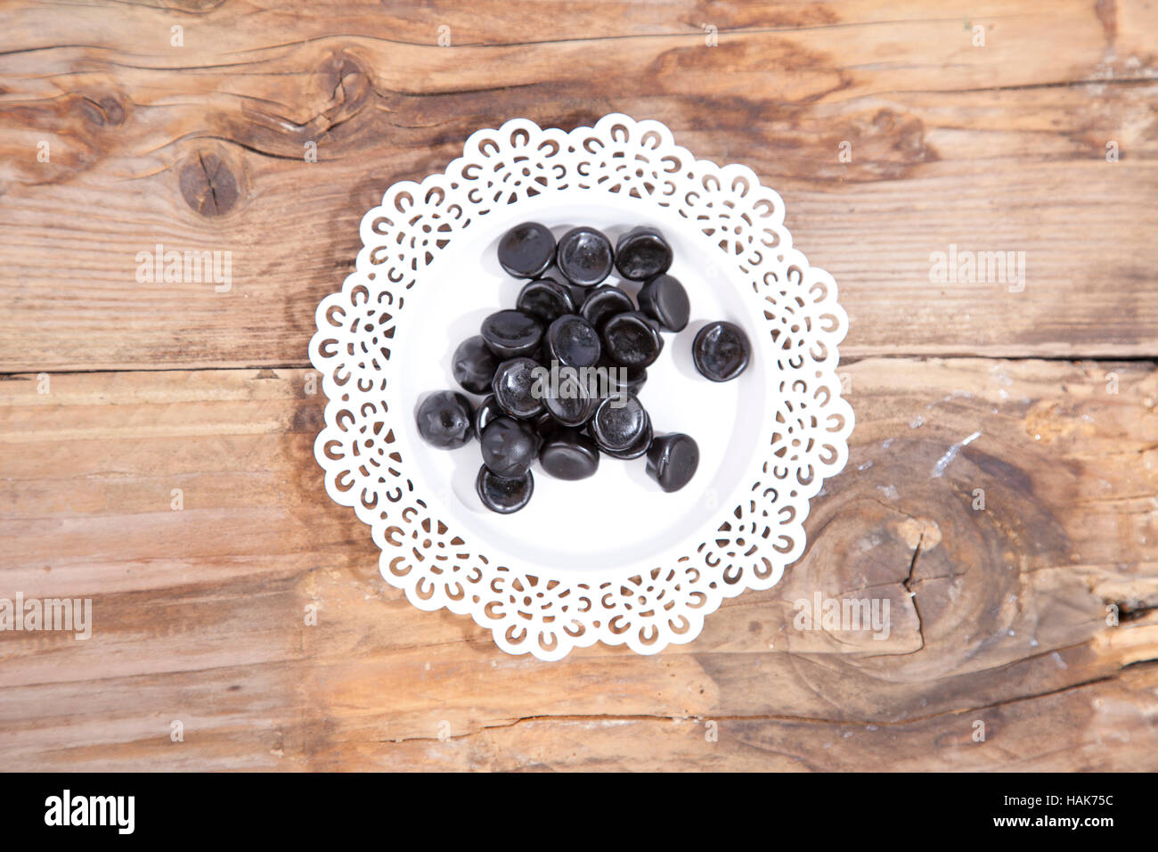 Traditional Dutch candy drop on little plate on wooden background Stock ...