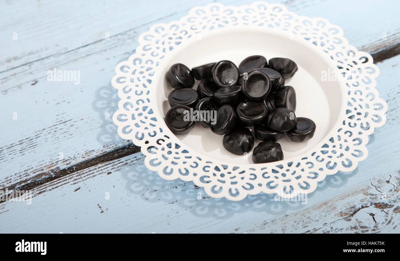 Traditional Dutch candy drop on little plate on wooden background Stock ...