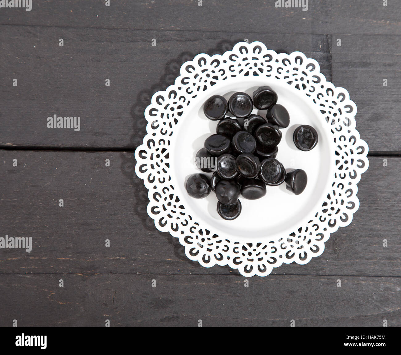 Traditional Dutch candy drop on little plate on wooden background Stock ...