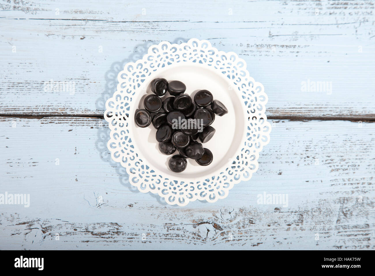 Traditional Dutch candy drop on little plate on wooden background Stock ...