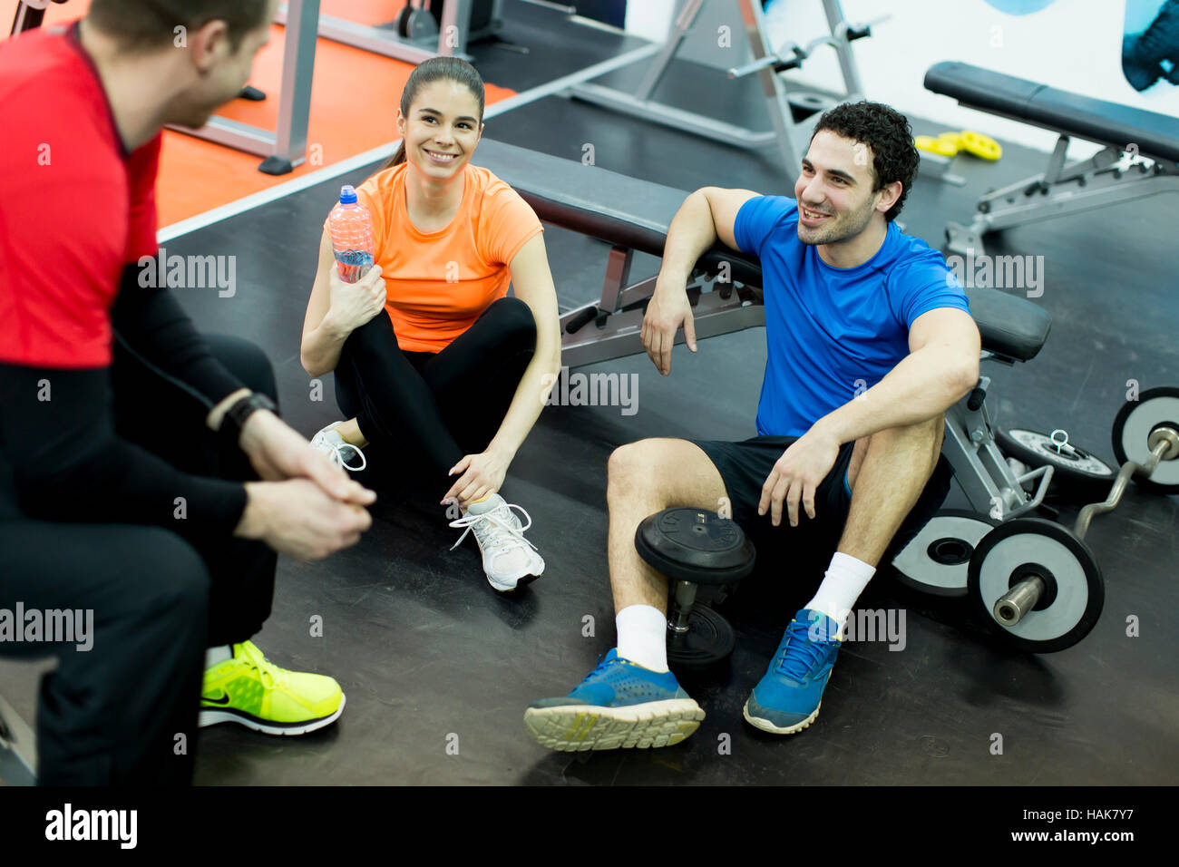 Young people resting at gym after a workout Stock Photo - Alamy