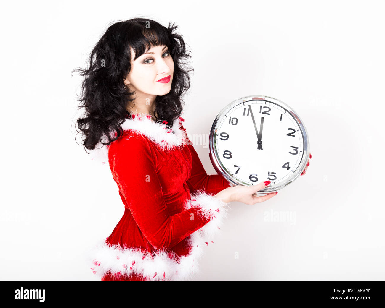 young beautiful woman in red coat holding big clock. time concept Stock ...