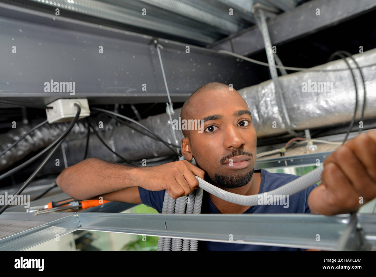 Young worker connecting wires Stock Photo - Alamy