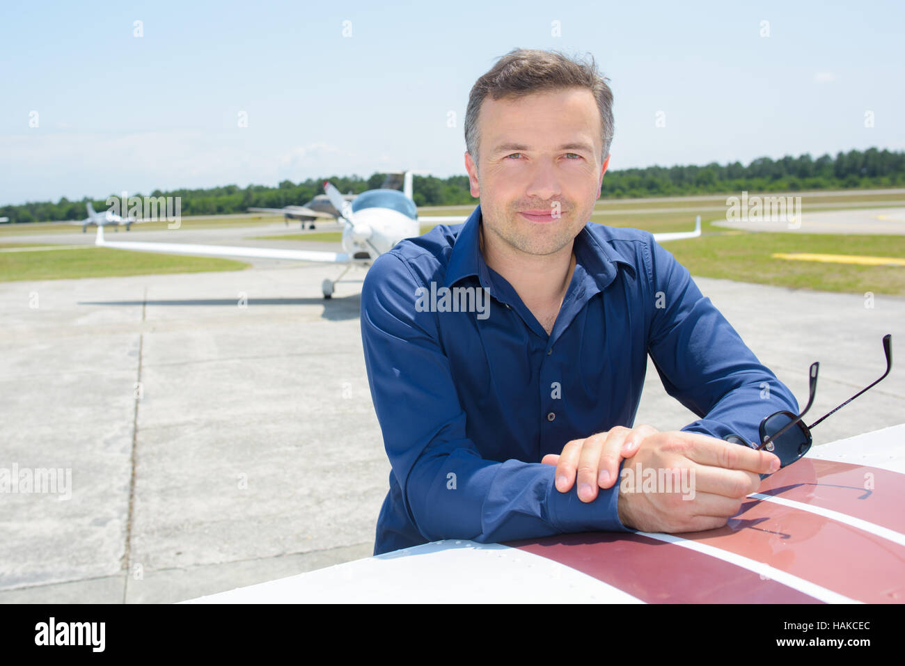 Portrait of man next to aircraft Stock Photo - Alamy