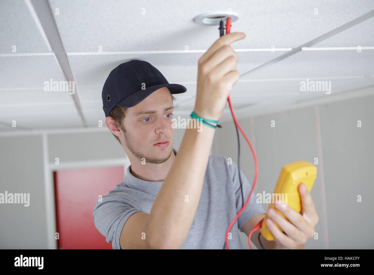 Young electrician testing spotlight socket Stock Photo - Alamy