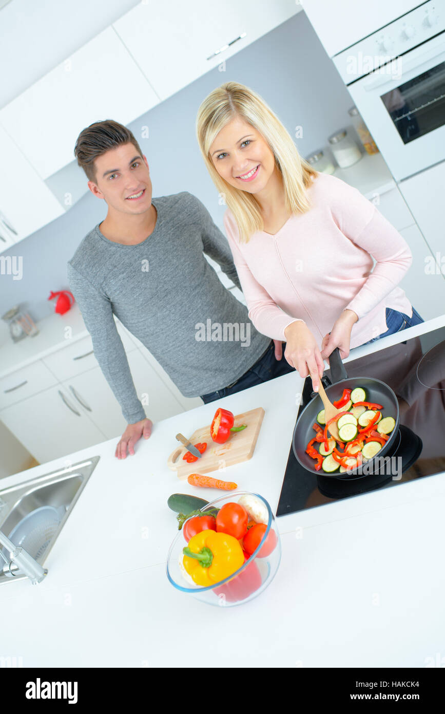 young couple cooking in their kitchen Stock Photo - Alamy