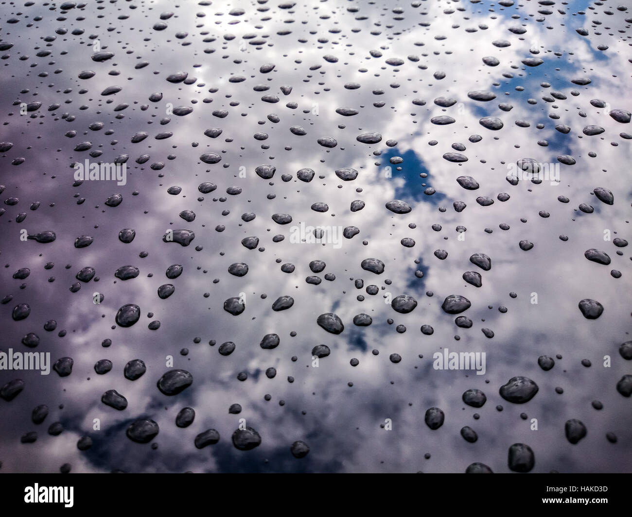 Raindrop on car with sky as background Stock Photo - Alamy