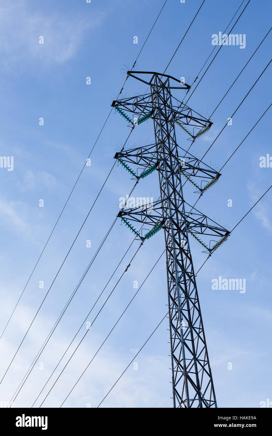High voltage pole against blue sky Stock Photo - Alamy