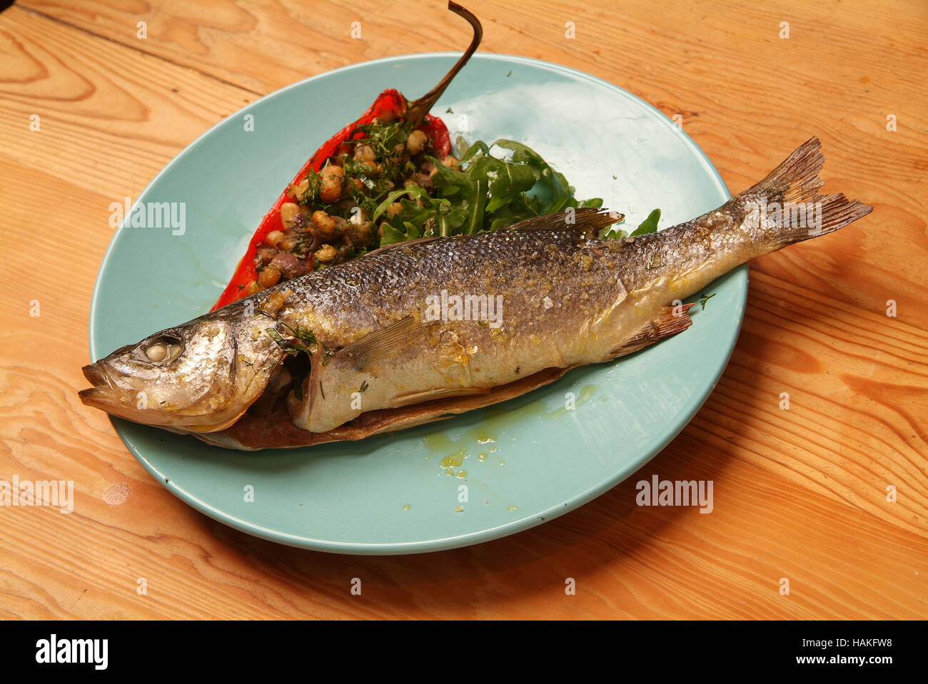 A whole cooked Brown Trout on a green plate Stock Photo - Alamy
