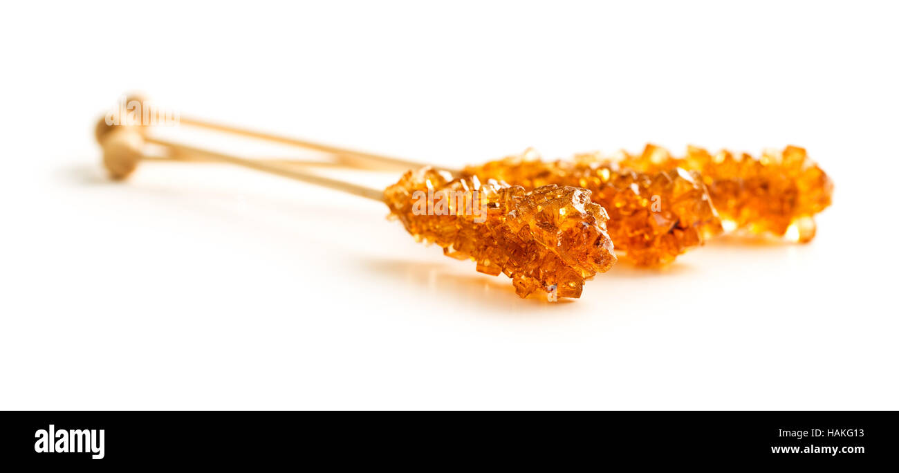 Brown amber sugar crystal on wooden stick isolated on white background ...