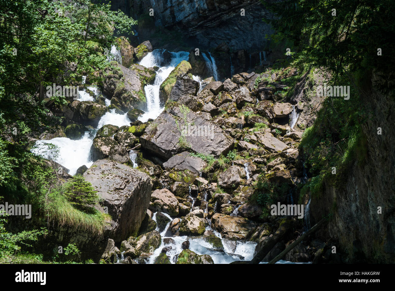 A stream flowing across rocks in the Swiss mountains Stock Photo - Alamy