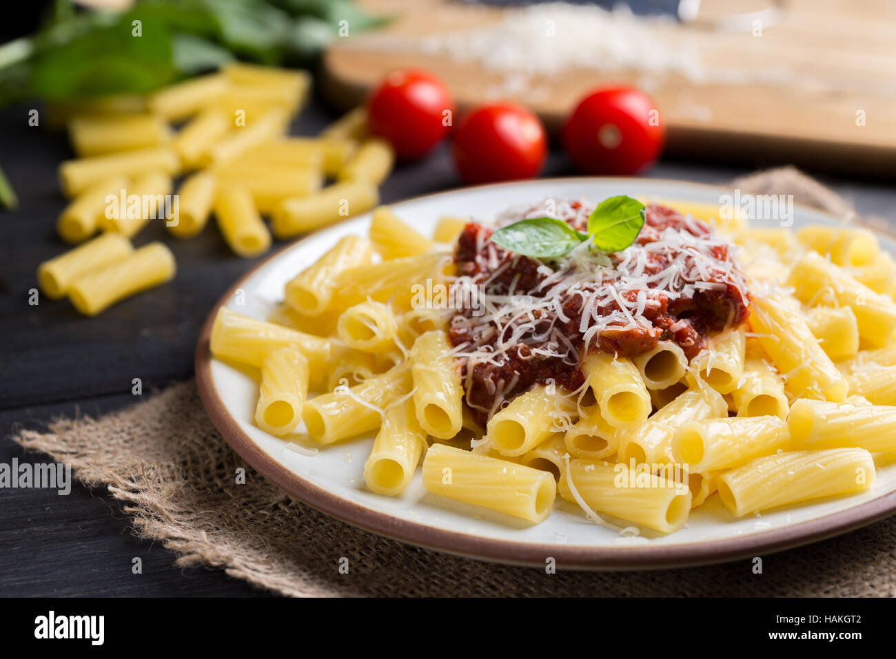 Pasta in white plate on natural wooden table Stock Photo - Alamy