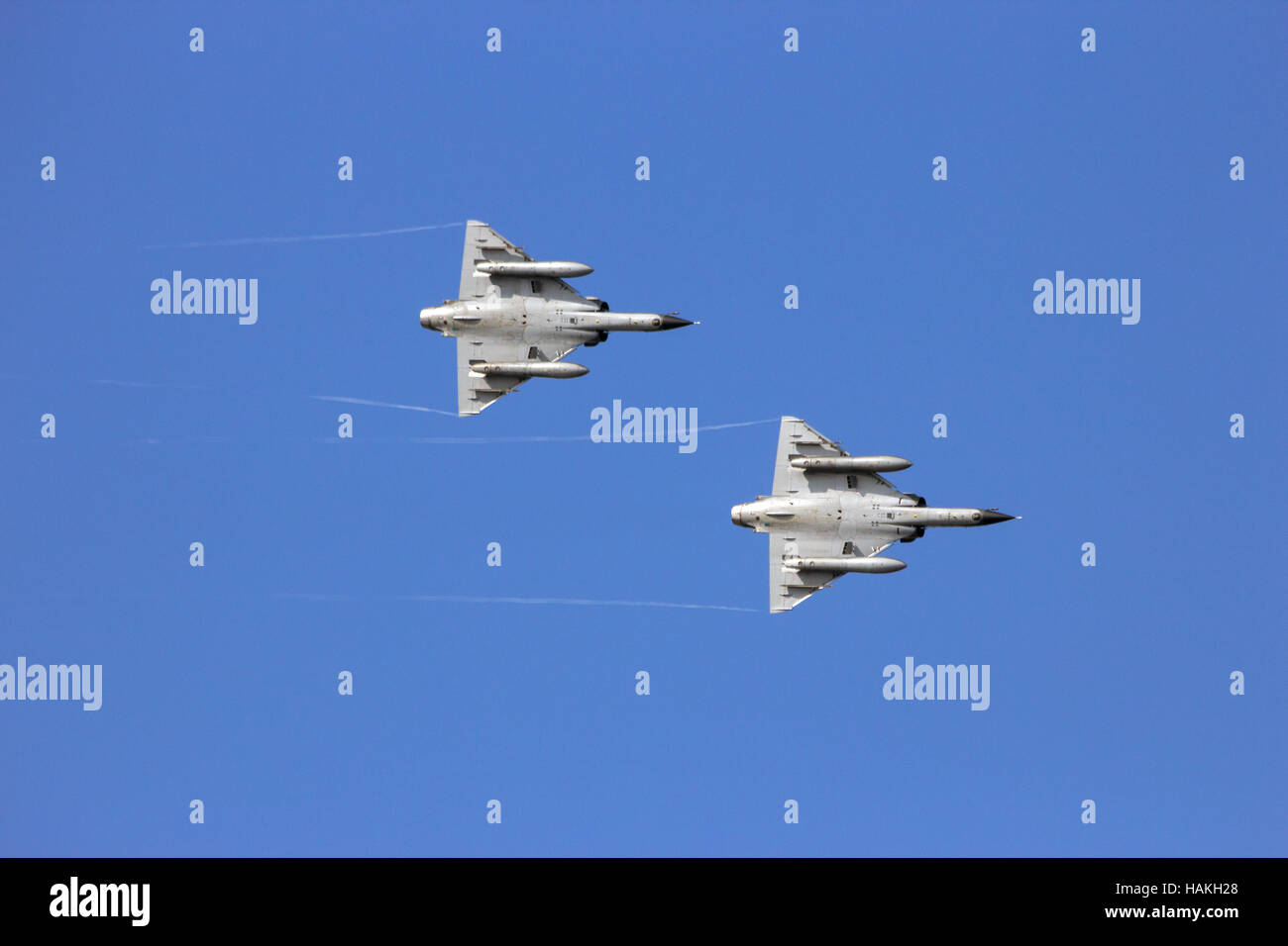 Two fighter jets flyby on a blue sky Stock Photo - Alamy