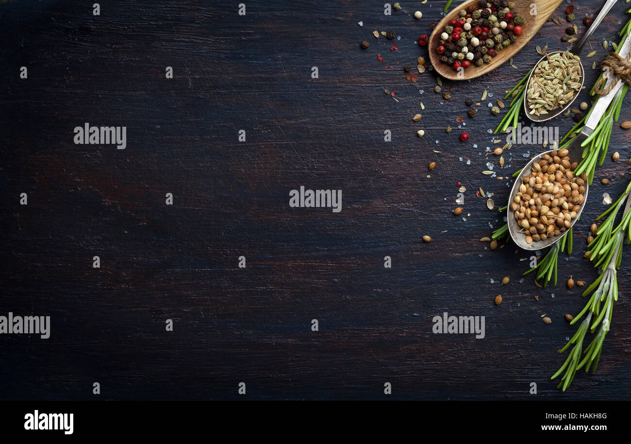 Various herbs and spices on dark wood table Stock Photo - Alamy