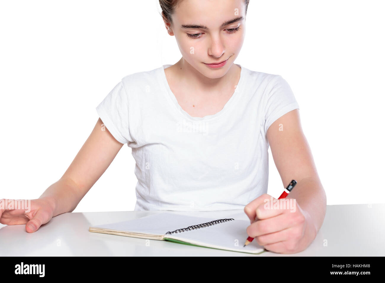 smiling teenage girl is doing her homework Stock Photo - Alamy