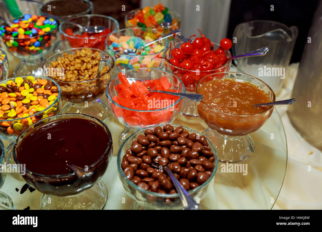 Assorted chocolate candy in a glass Candies in glass jars in candy shop ...