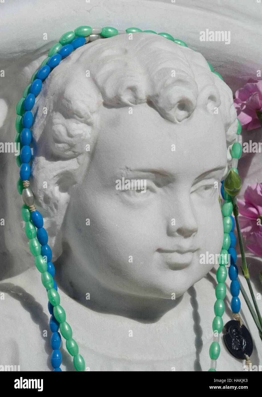 Close up of grave memorial of Baby Jesus with rosary beads as crown ...