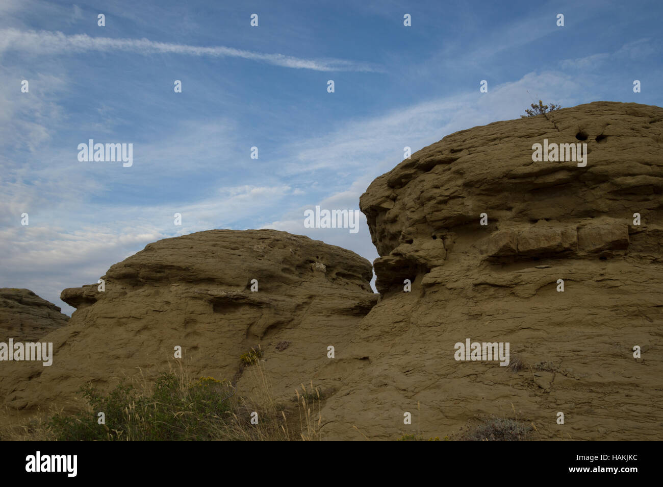 Sandstone rock formations photographed from an angle with blue sky and ...