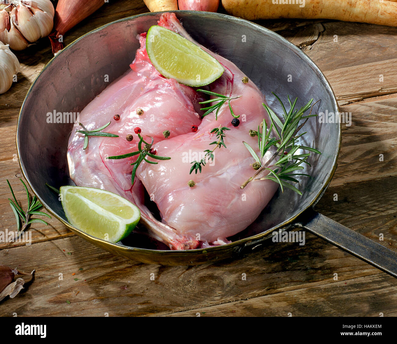 Rabbit legs in pan on a wooden board Stock Photo - Alamy