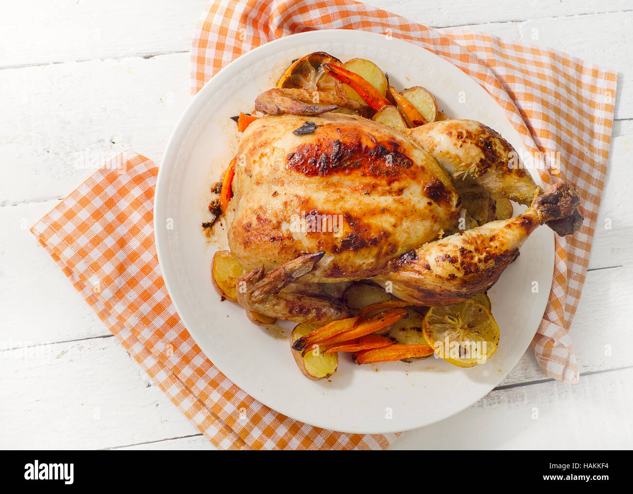 Whole roasted chicken with vegetables on a white plate. Top view Stock ...