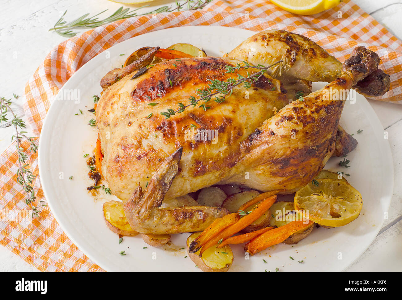 Whole roasted chicken with vegetables on white plate Stock Photo - Alamy