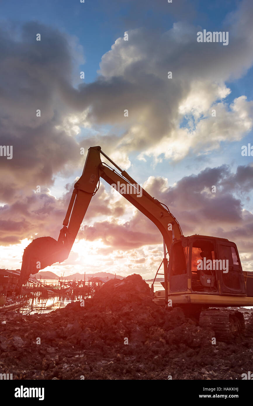 Excavator operator downtime waiting sunset Stock Photo - Alamy