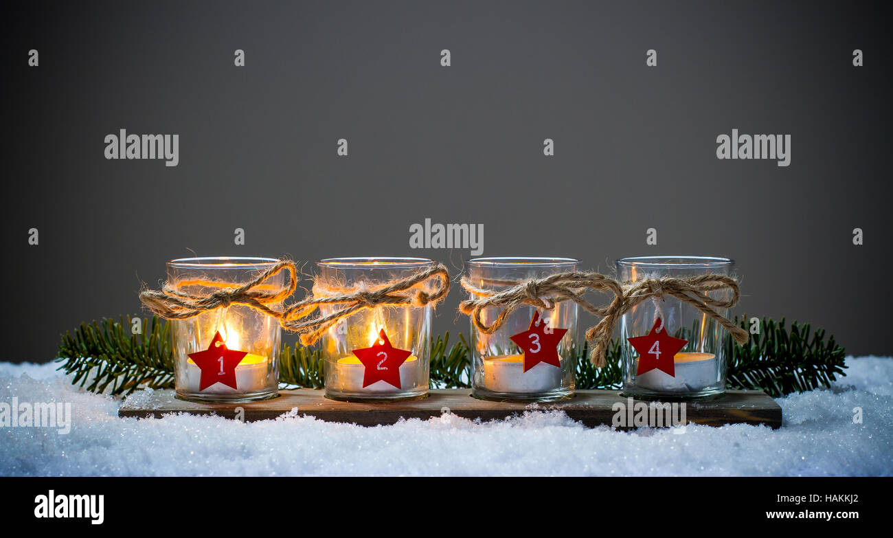 Four Advent candles in the snow, second Advent Stock Photo - Alamy
