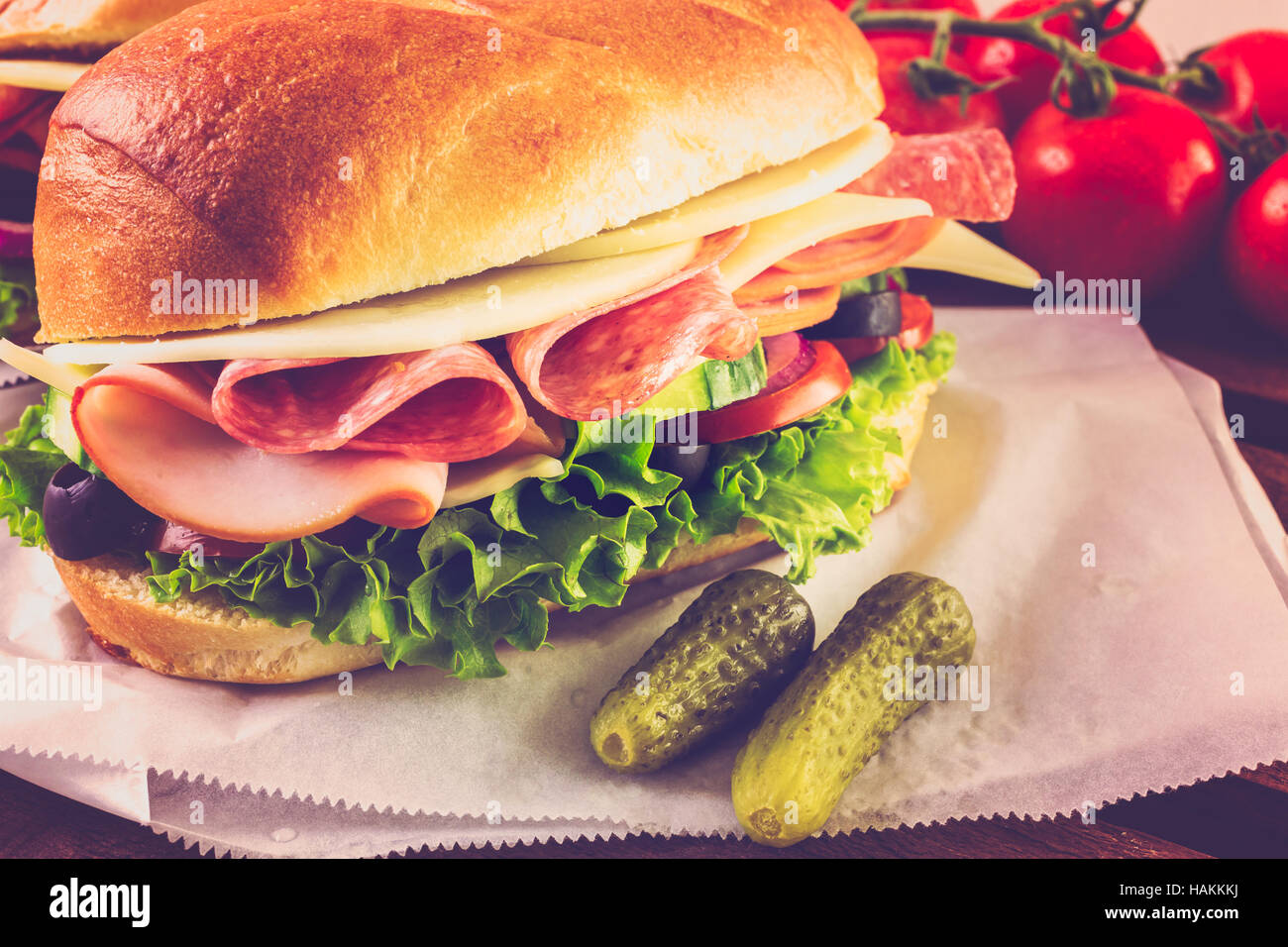 Sub sandwich with fresh vegetables, lunch meat and cheese on hoagie ...