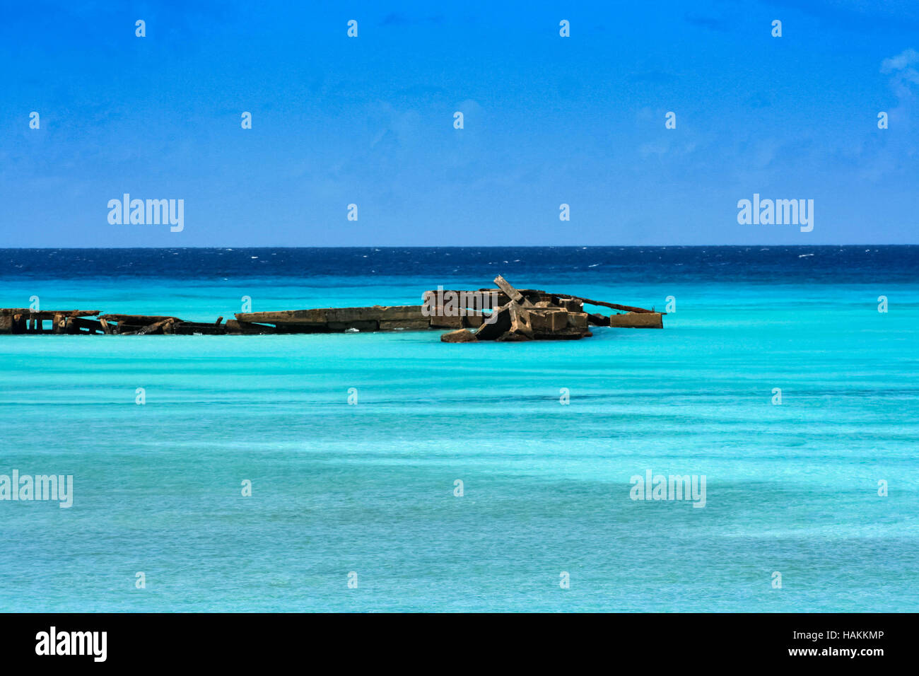 Old pier on bright blue water Stock Photo - Alamy