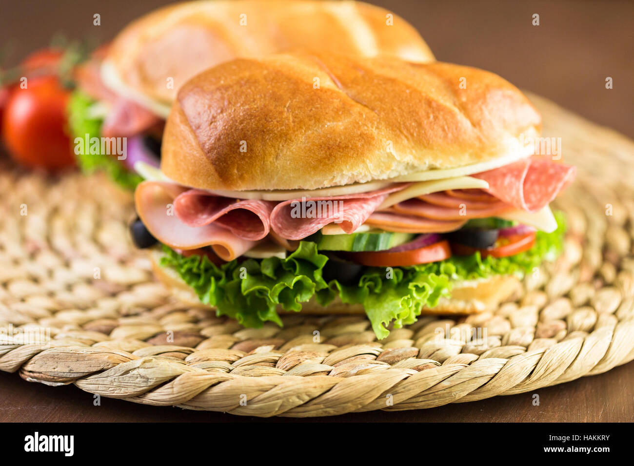Sub sandwich with fresh vegetables, lunch meat and cheese on hoagie ...