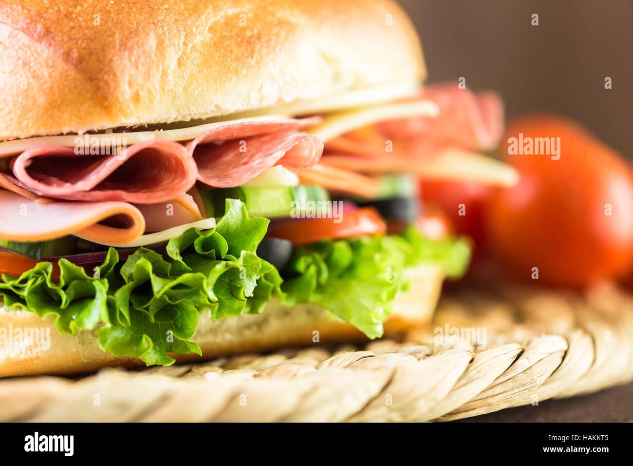 Sub sandwich with fresh vegetables, lunch meat and cheese on hoagie ...