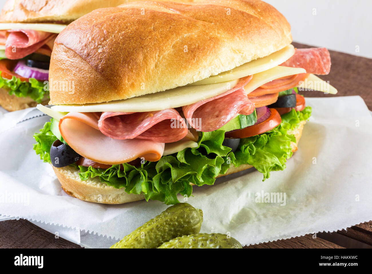 Sub sandwich with fresh vegetables, lunch meat and cheese on hoagie ...