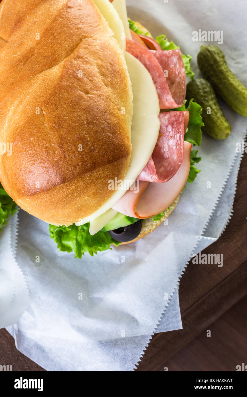 Sub sandwich with fresh vegetables, lunch meat and cheese on hoagie ...
