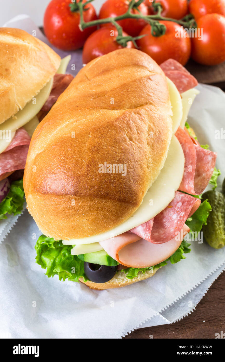 Sub sandwich with fresh vegetables, lunch meat and cheese on hoagie ...