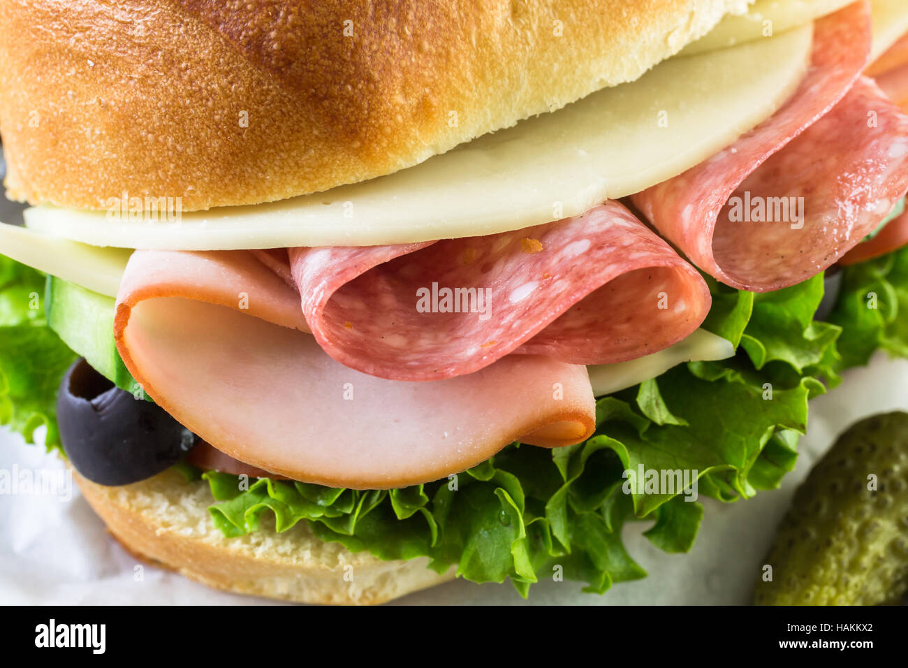 Sub sandwich with fresh vegetables, lunch meat and cheese on hoagie ...