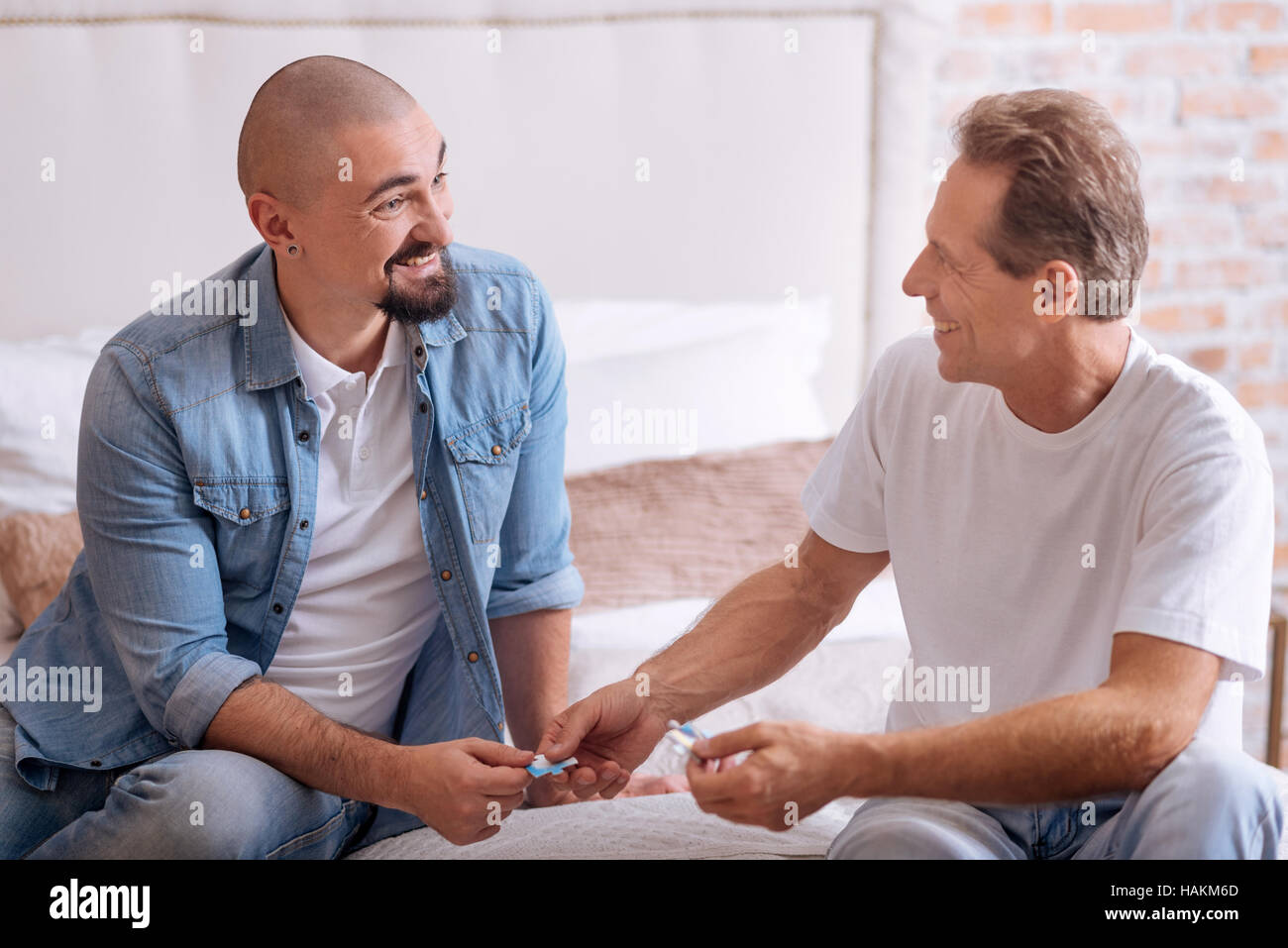Joyful friends playing in a puzzle game at home Stock Photo - Alamy