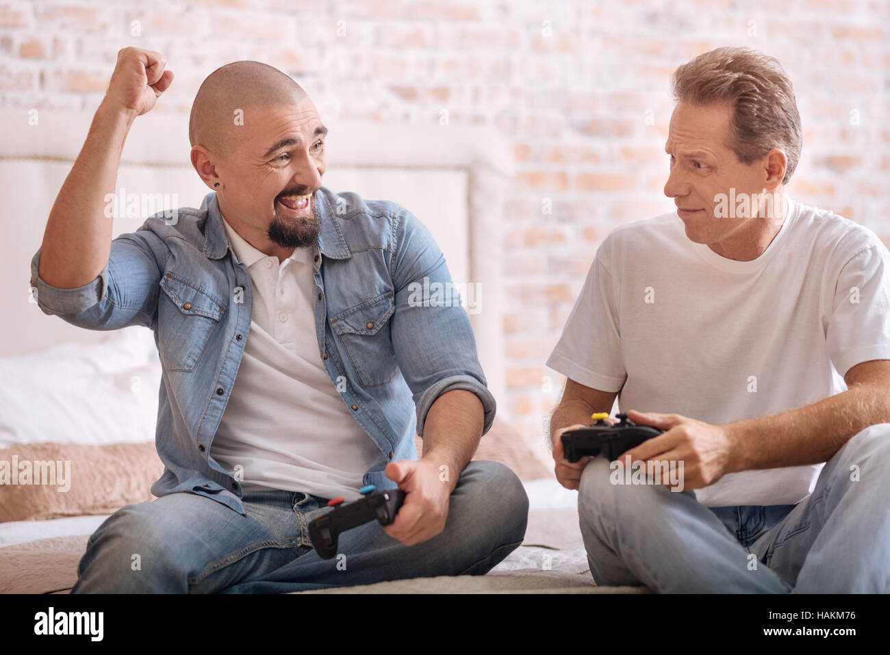 Childish friends playing with game console at home Stock Photo - Alamy
