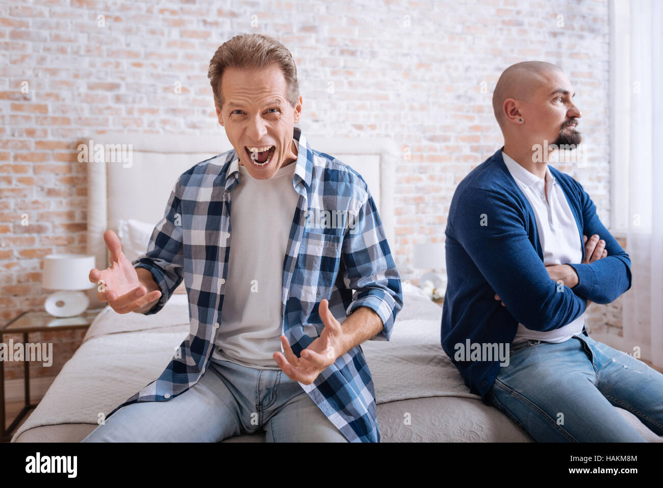 Inflamed man screaming loudly at home Stock Photo - Alamy