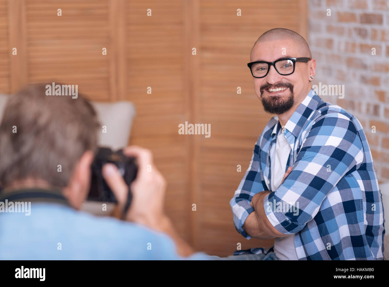 Smiling young man posing for the photographer Stock Photo - Alamy